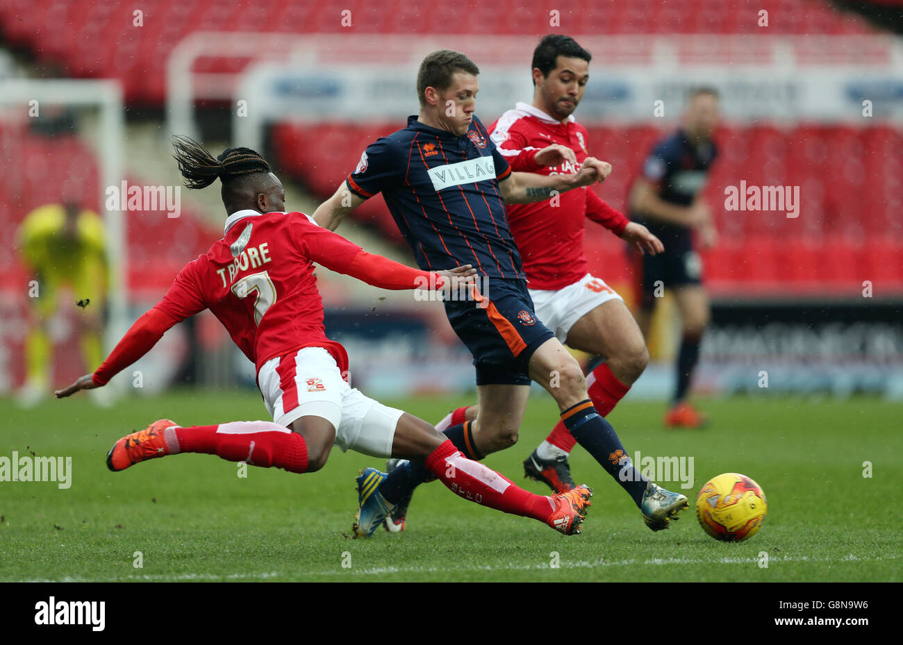 Swindon Town's Drissa Traore and Blackpool's Jim McAlister (centre ...