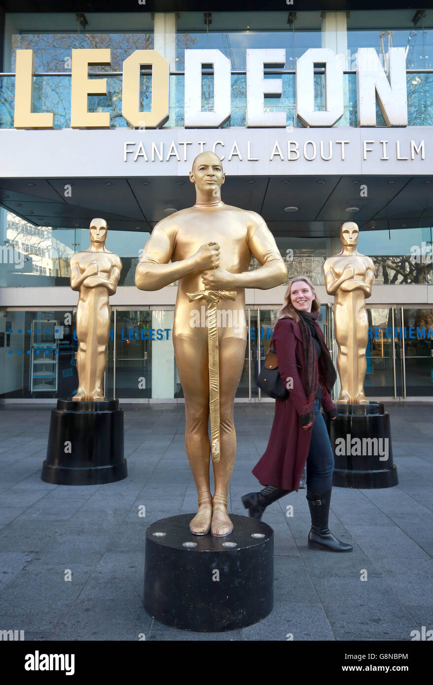A living Oscar statue in front of a newly-installed sign at ODEON ...