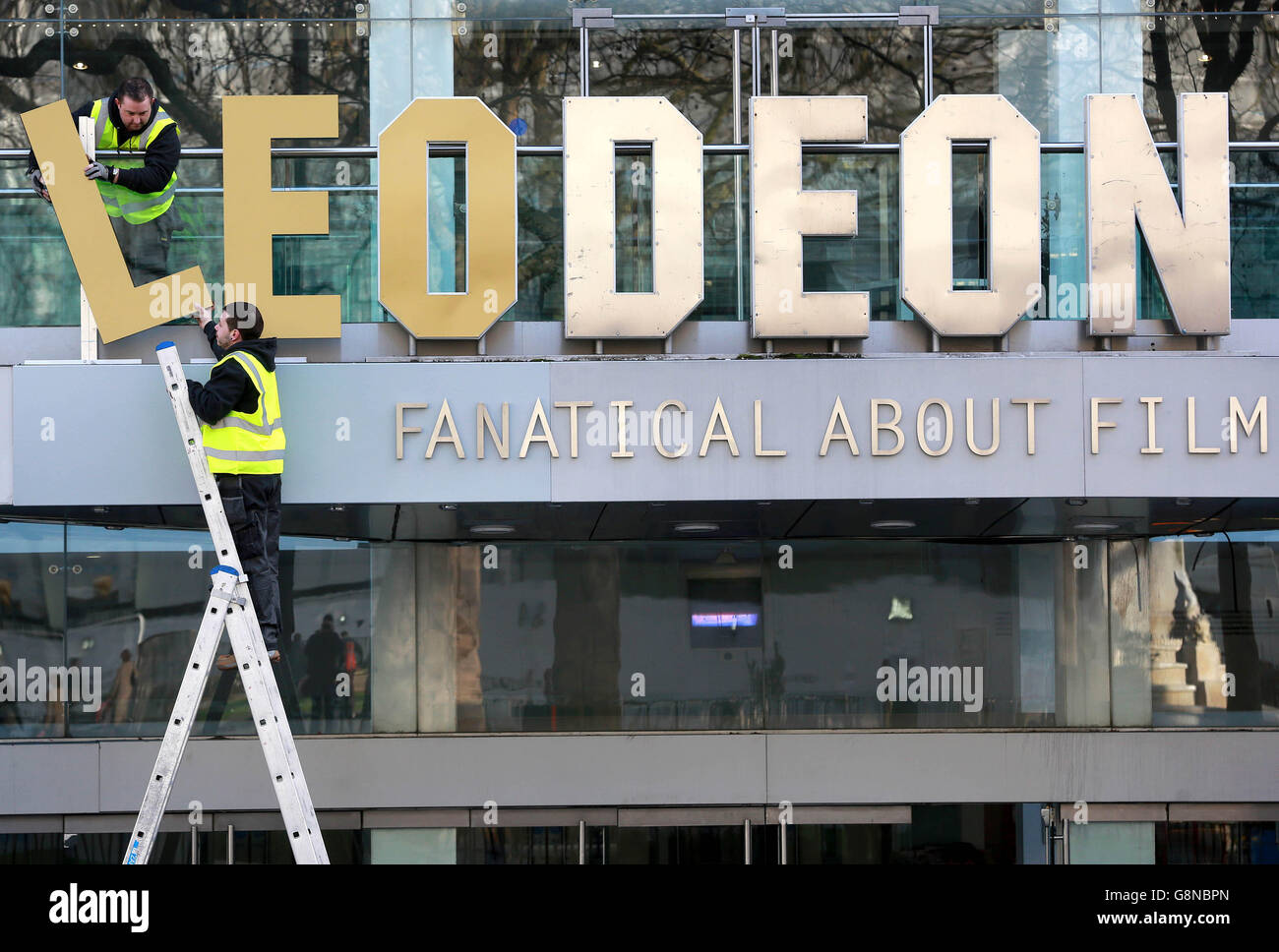 Builders Matthew Townsley (left) and Michael Groom install a sign at ...