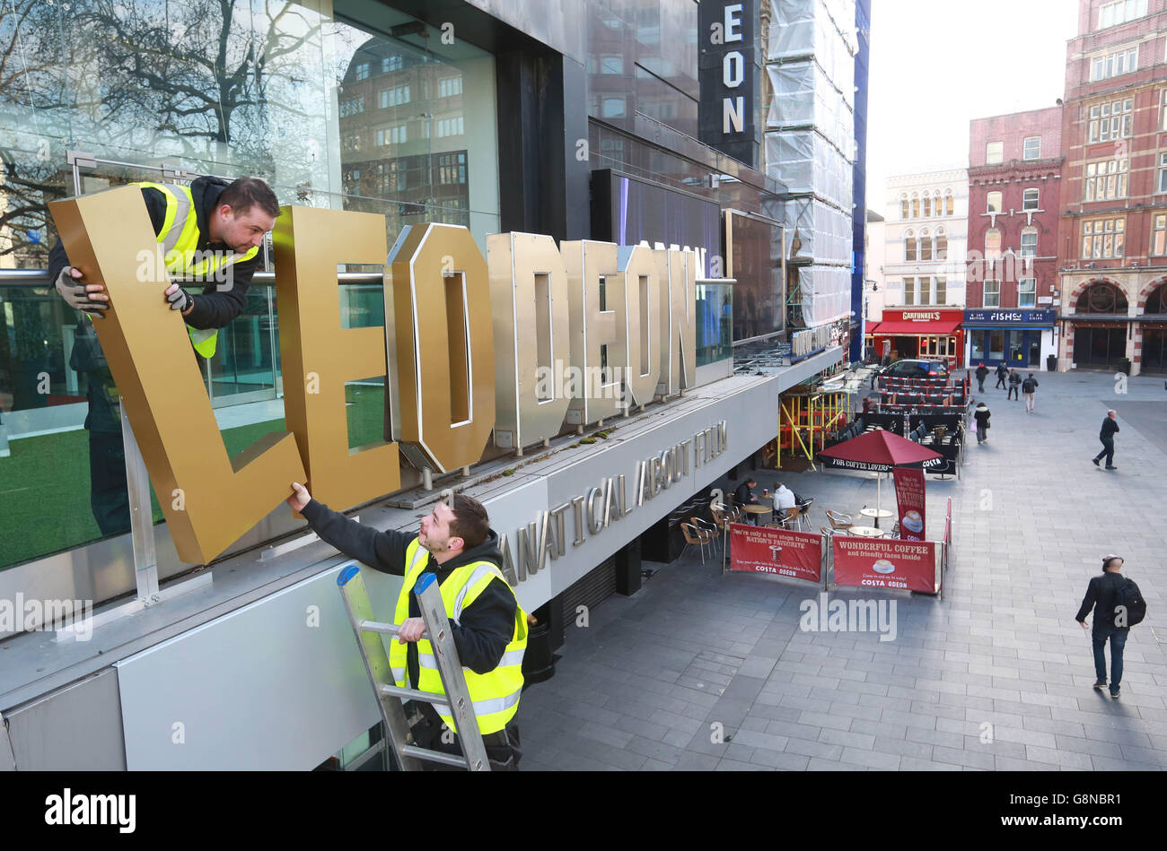 Builders Matthew Townsley (left) and Michael Groom install a sign at ...