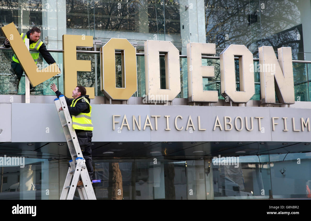 Builders Matthew Townsley (left) and Michael Groom install a sign at ...