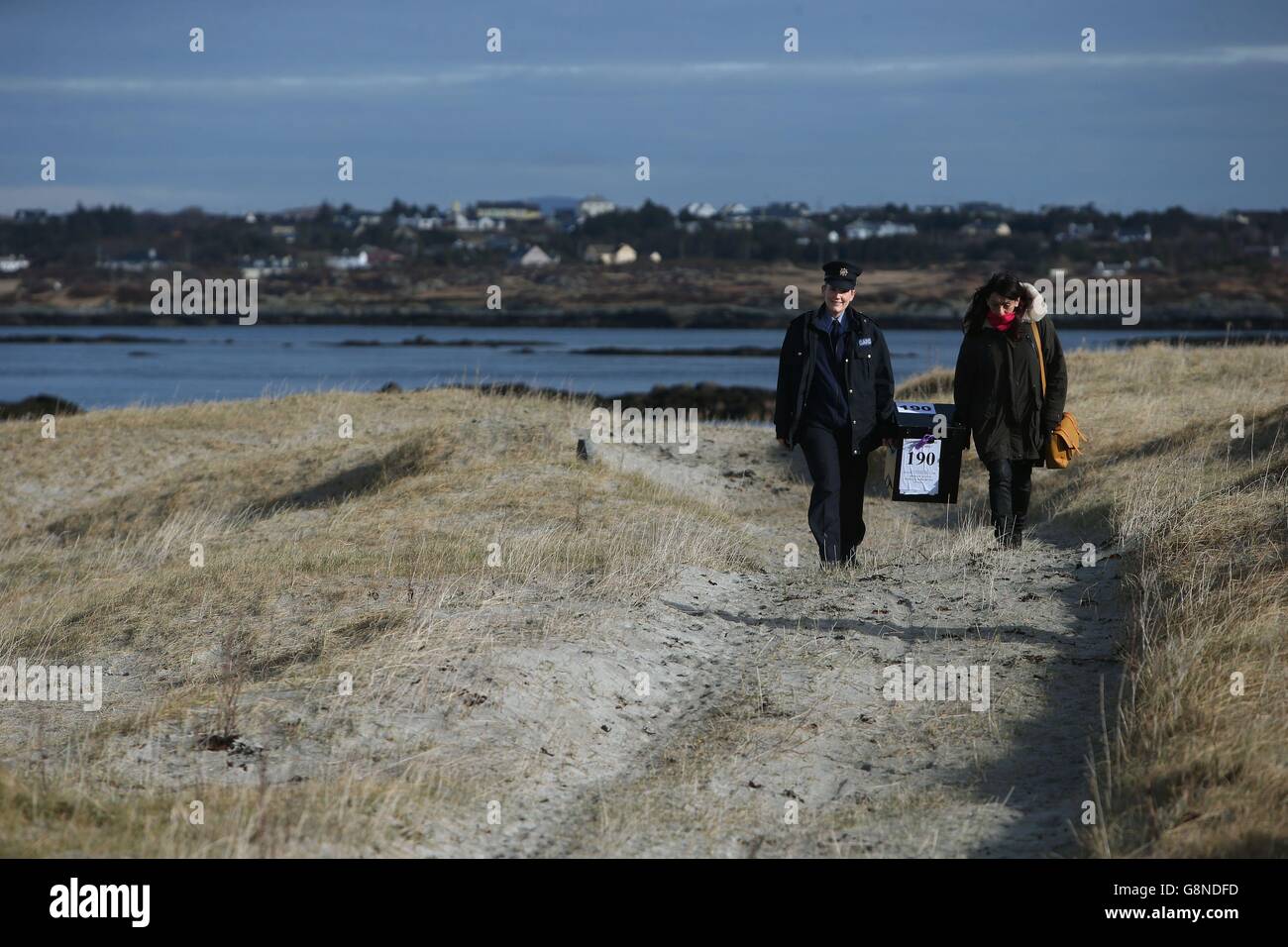 Garda Margaret Byrne (left) and presiding officer Majella Harkin carry ...