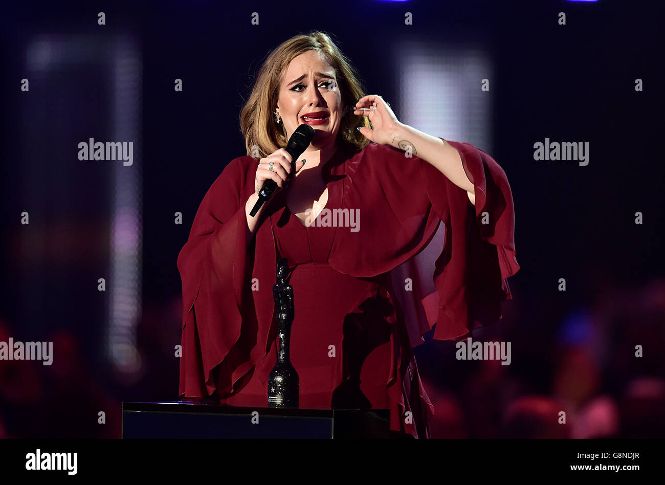 Adele collects tAdele collects the Global Success Award on stage during ...