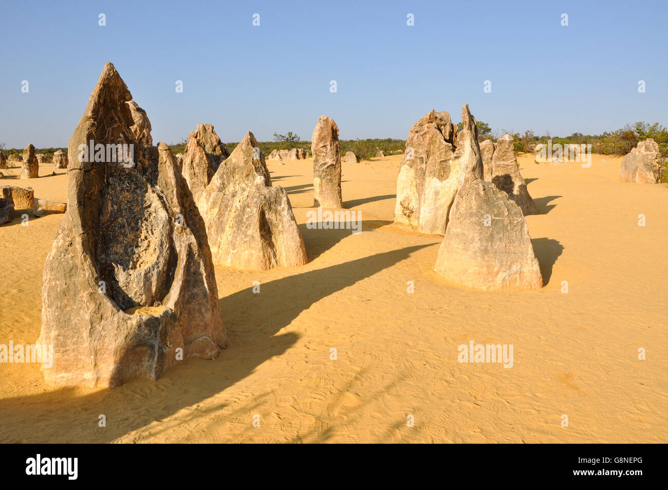 Unique limestone rock formations rising up out of the sand in the ...