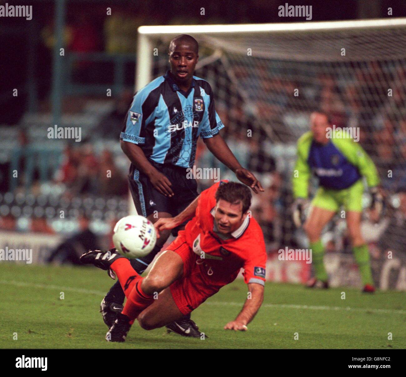 Coventry City's Paul Williams (left) keeps an eye on the ball as ...
