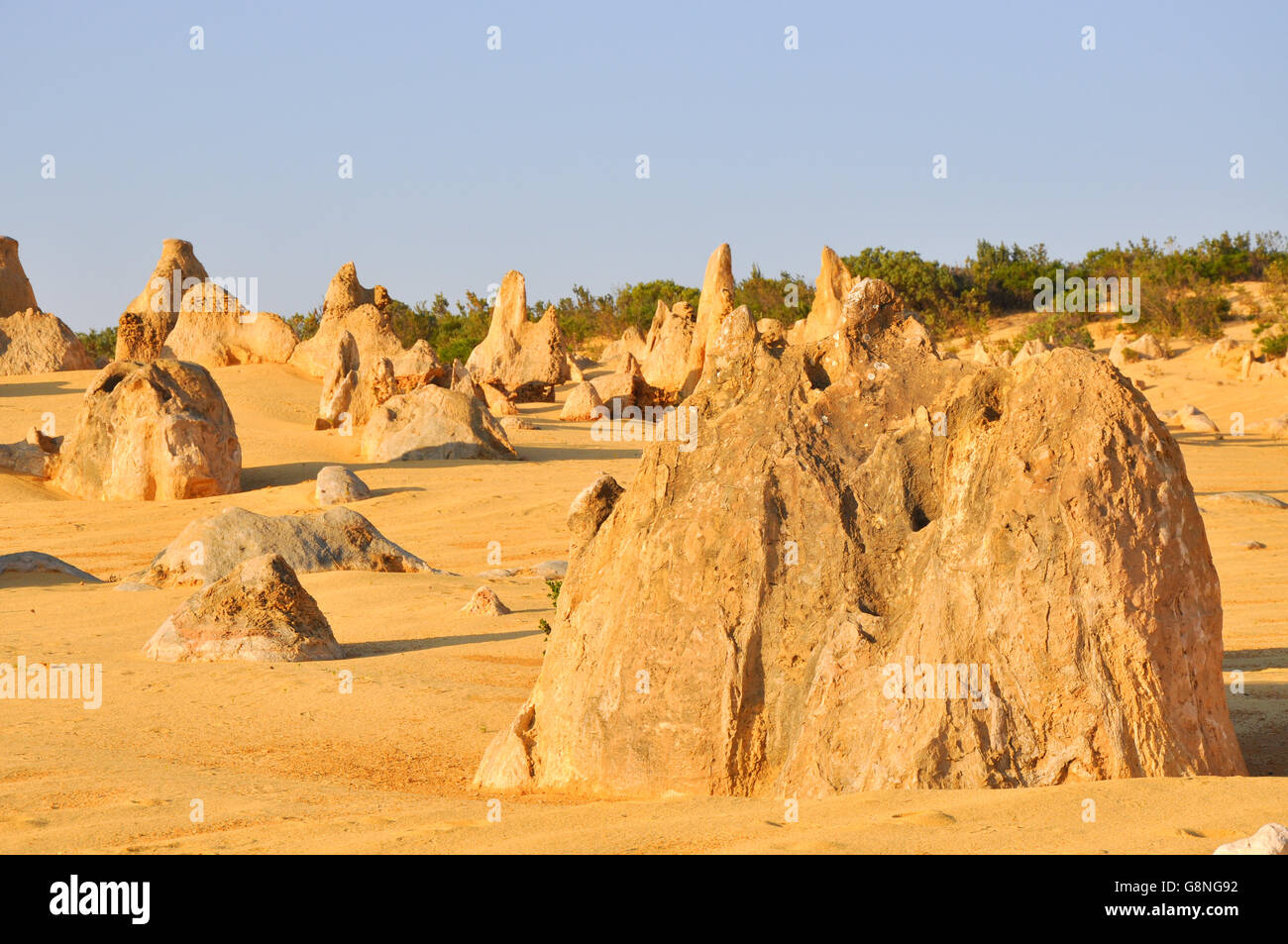 Unique limestone rock formations rising up out of the sand in the ...