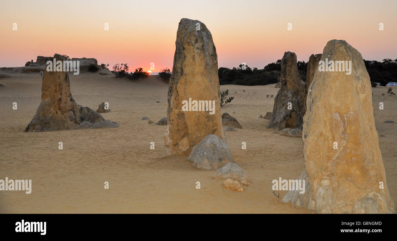 Limestone rock formations in the Pinnacles Desert under a sunset sky in ...