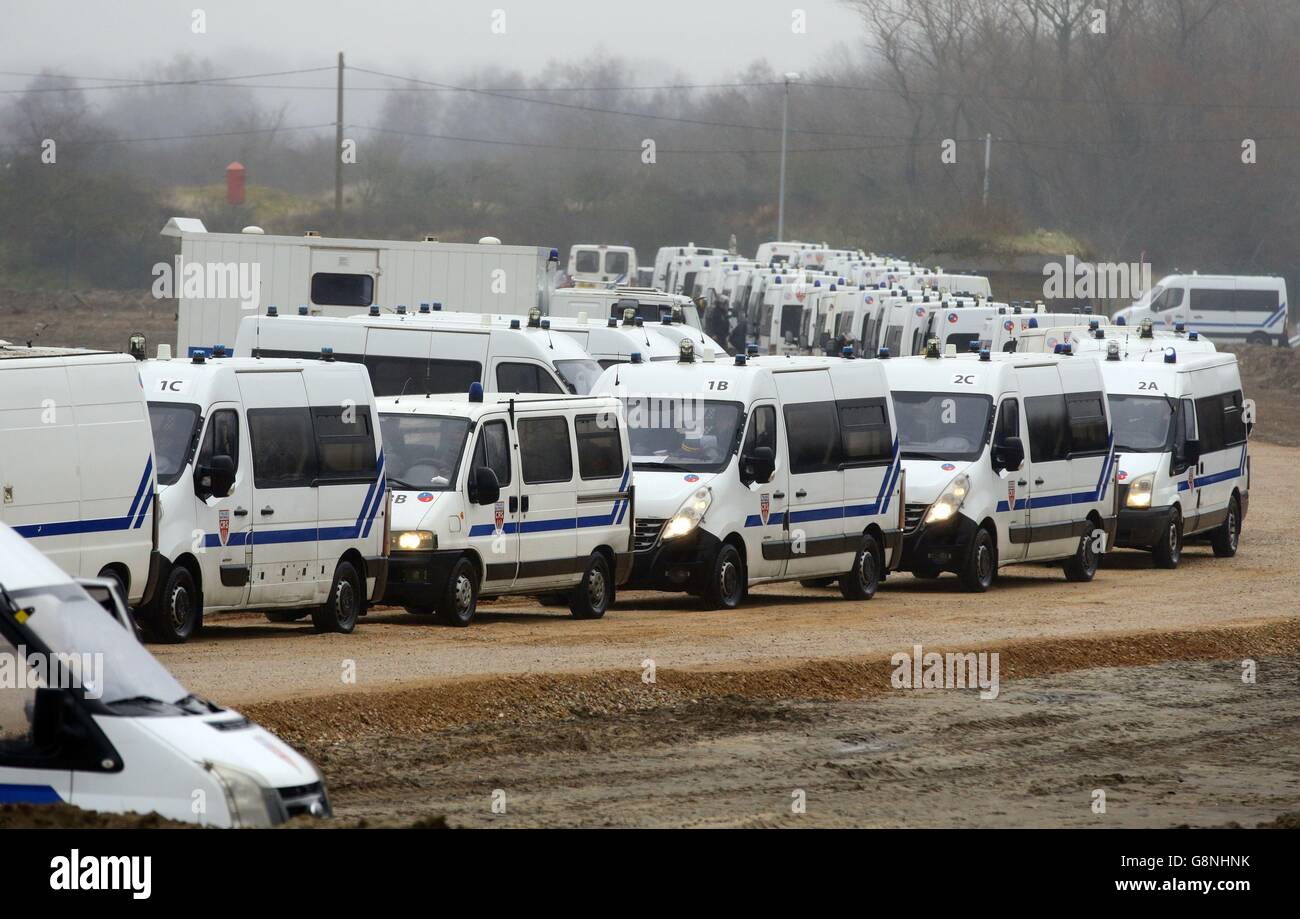French police vans wait outside an entrance as the demolition of parts ...