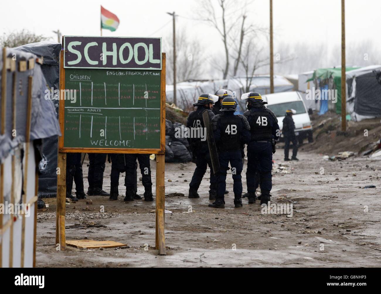 French riot police move through the Jungle as the demolition of parts ...