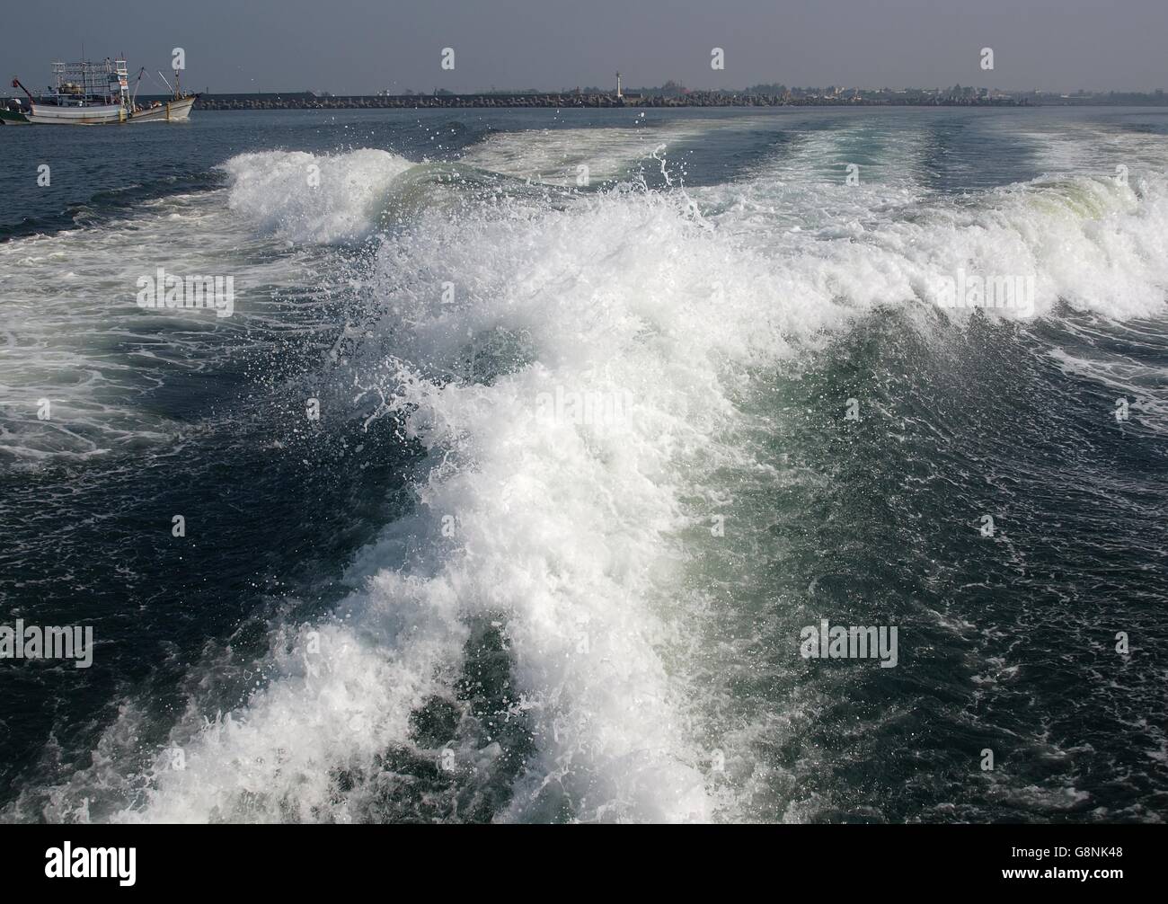 The engines of a powerful speedboat create a huge surf Stock Photo - Alamy
