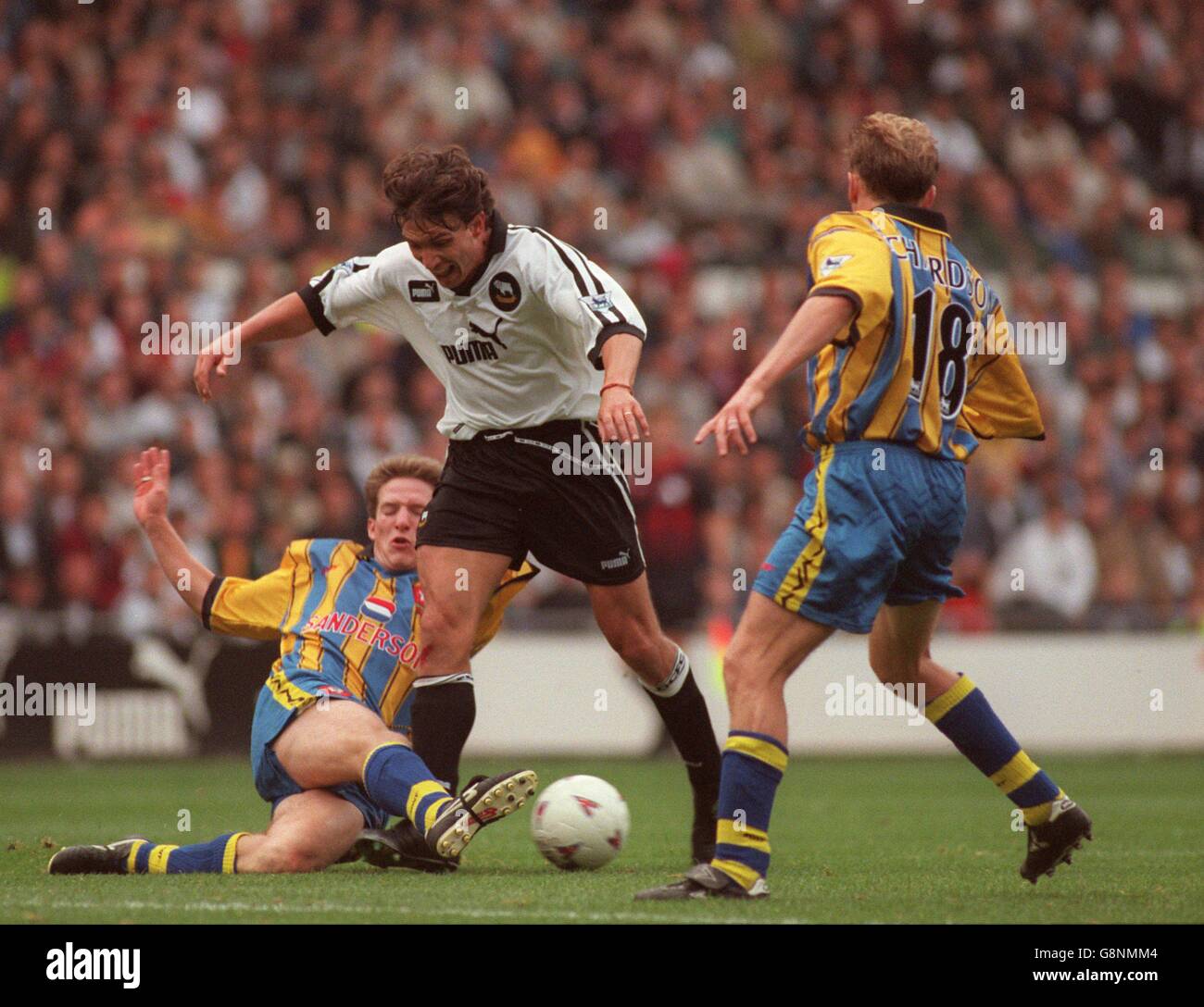 Stefano Eranio of Derby County (centre) tries to get through the ...