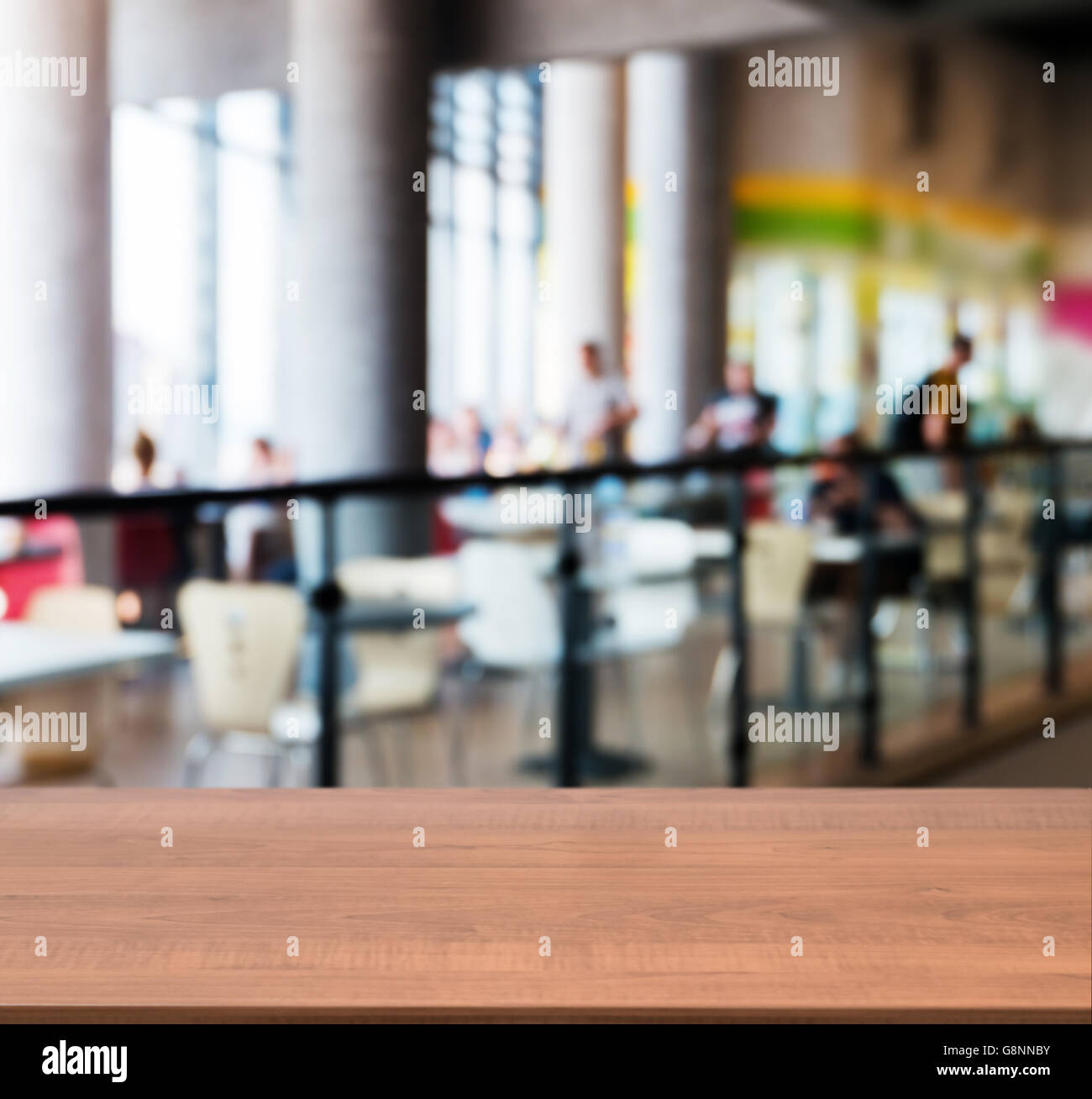 Wooden empty table in front of blurred people Stock Photo - Alamy