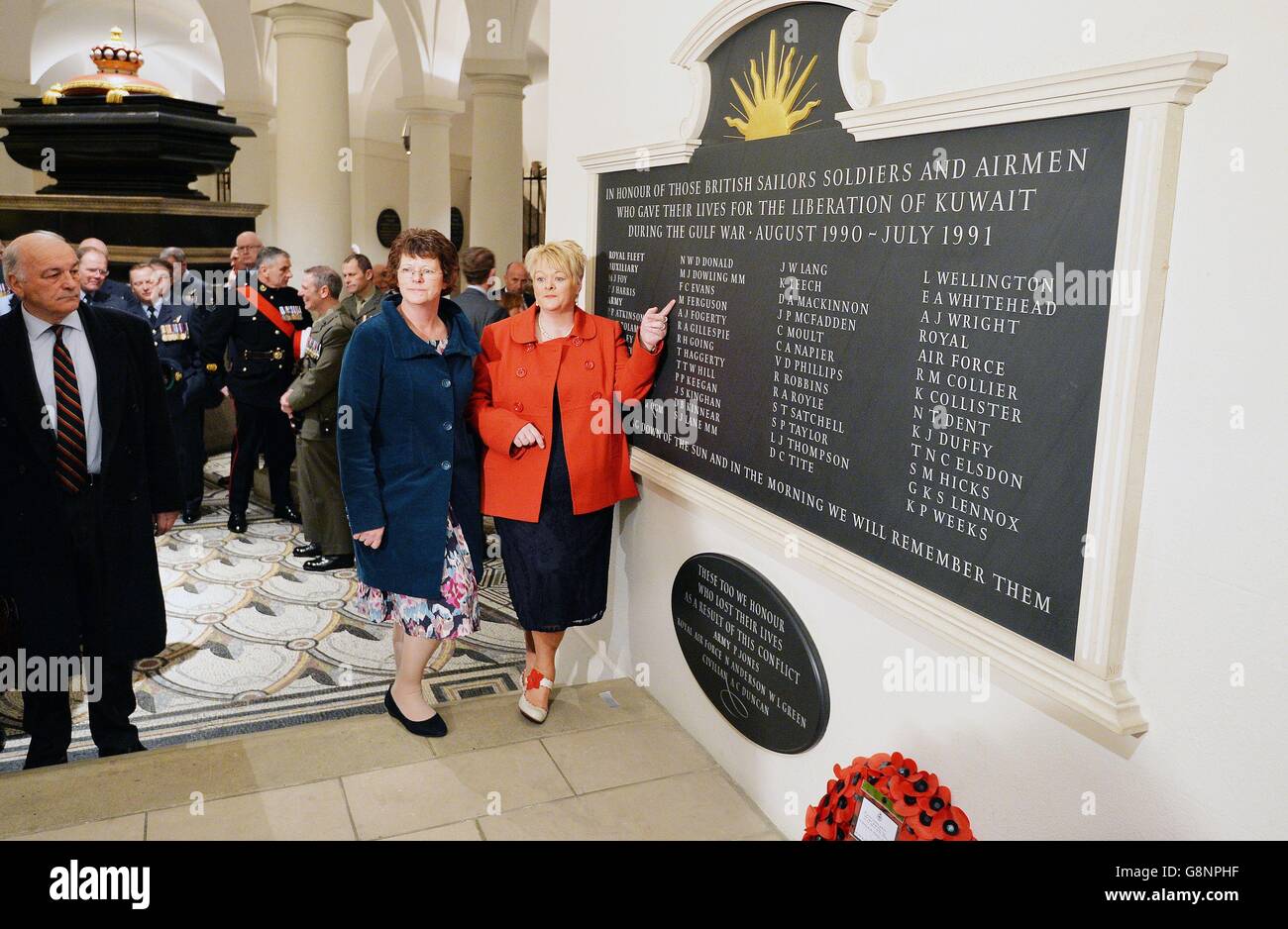 Alison Ferguson and Jacqueline Blackmore (in red) point to the name of ...