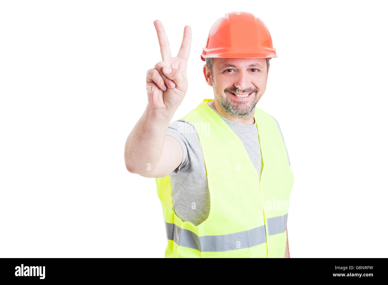 Handsome smiling workman or constructor with helmet showing victory ...