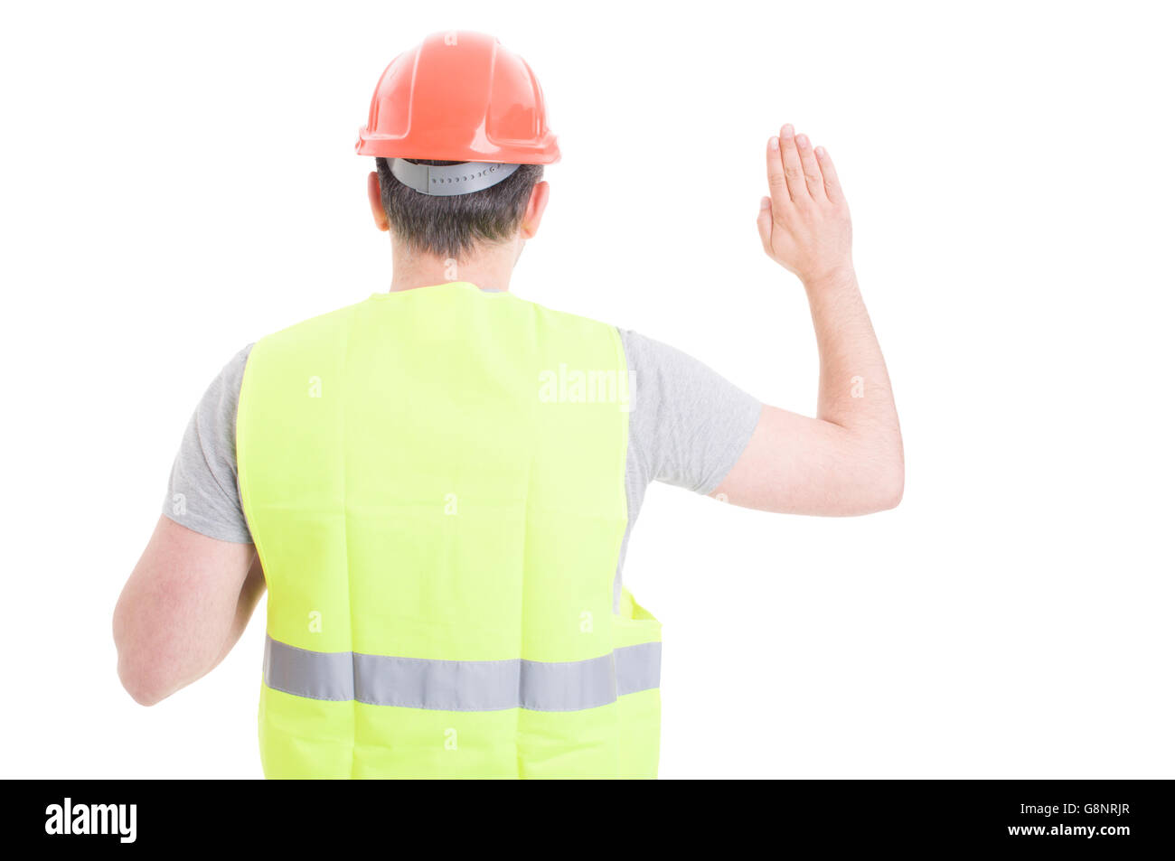 Back view of male constructor standing and doing a vow as pledge ...