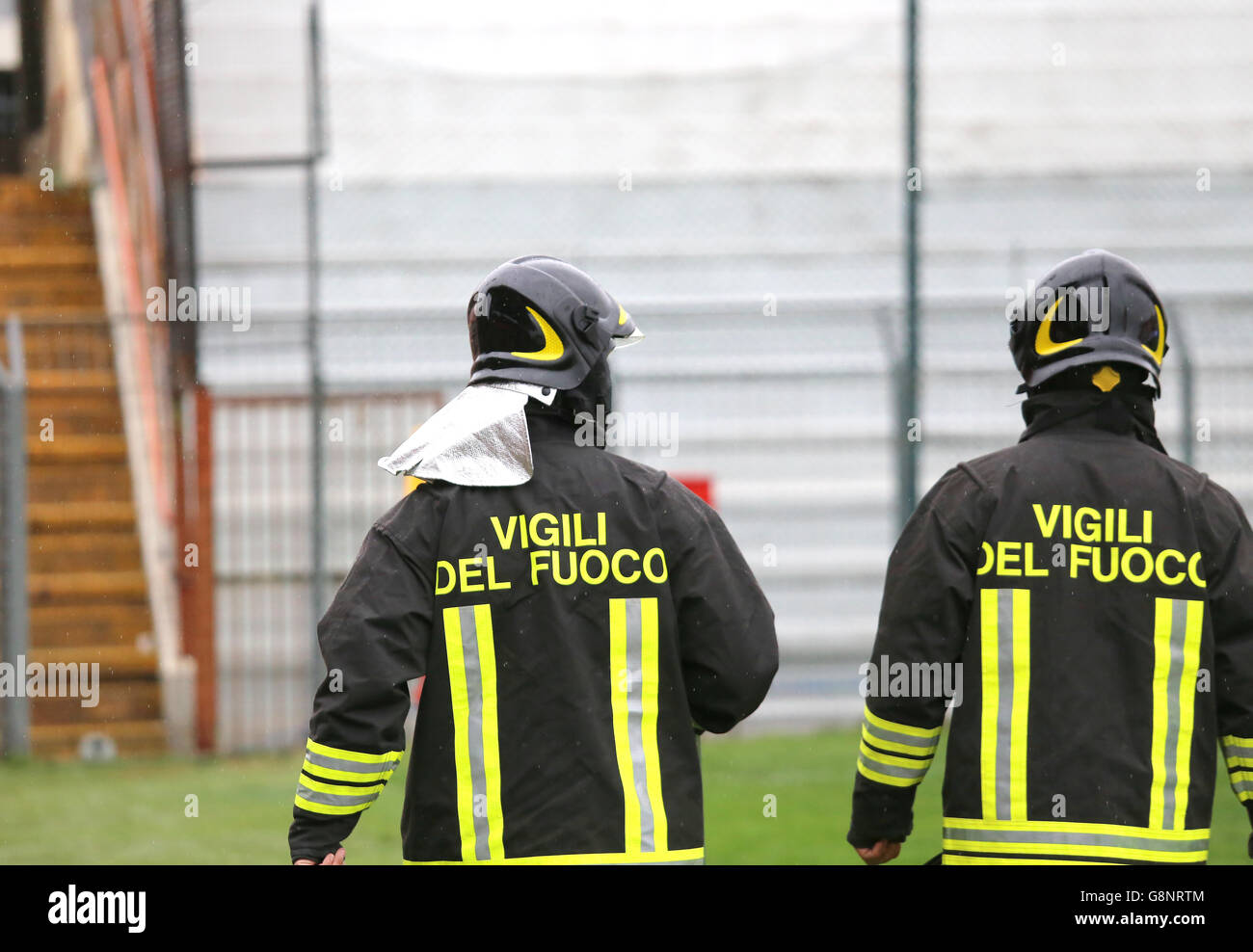 couple Italian firefighters with uniform with the written FIREFIGHTERS ...