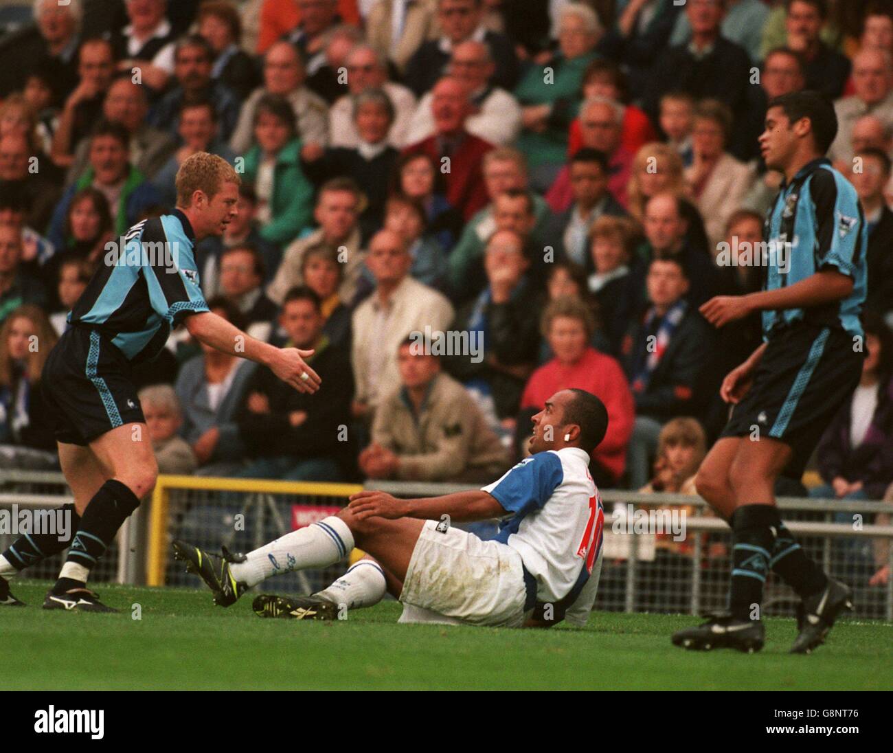 Coventry City's David Burrows (left) offers his hand to an angry Martin ...