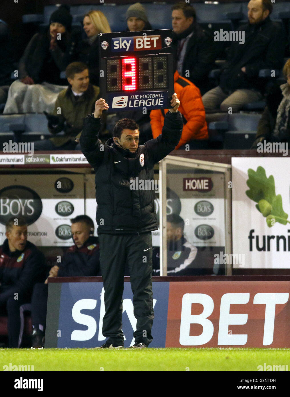 Fourth Official Tony Harrington holds aloft the electronic officials ...