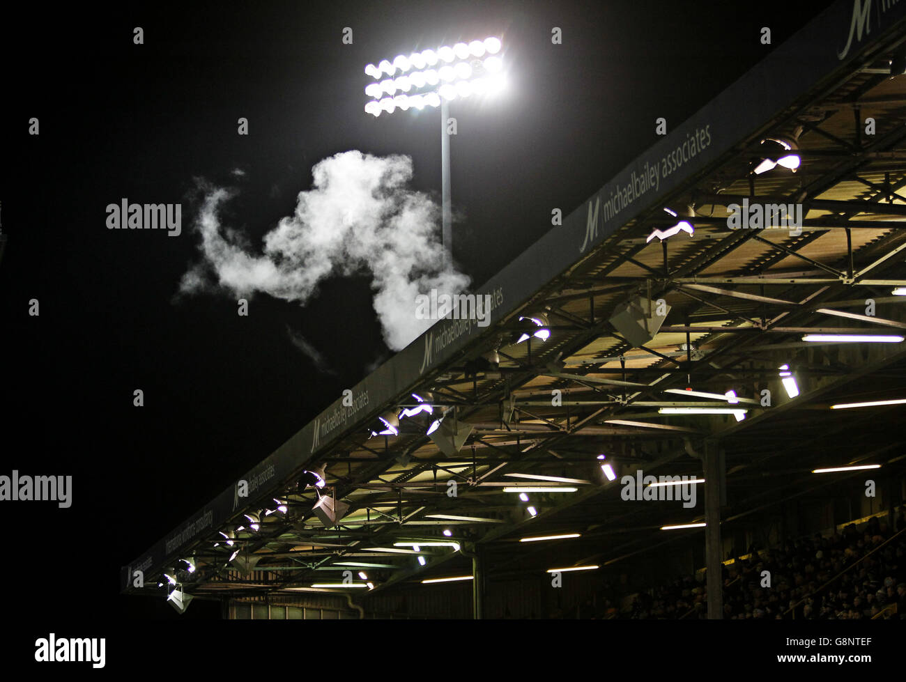 A general view of a floodlight and smoke at Turf Moor Stock Photo - Alamy