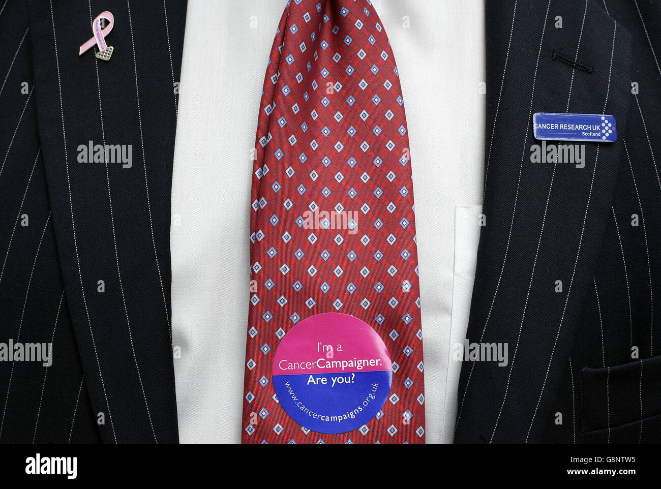 Chief Executive of Cancer Research UK, Alex Markham proudly displays ...