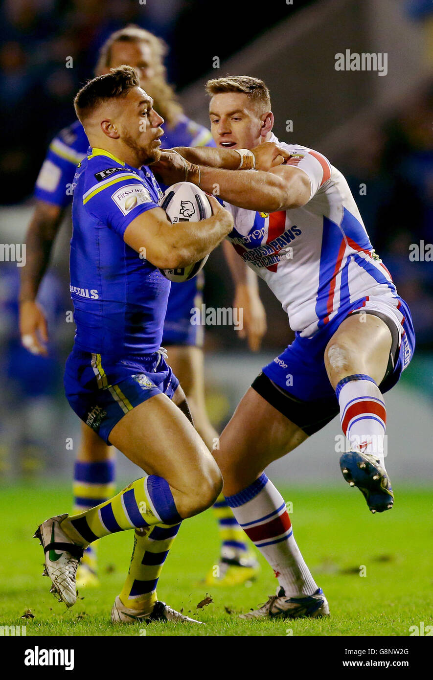 Warrington Wolves' Matty Russell (left) is tackled by Wakefield Trinity ...