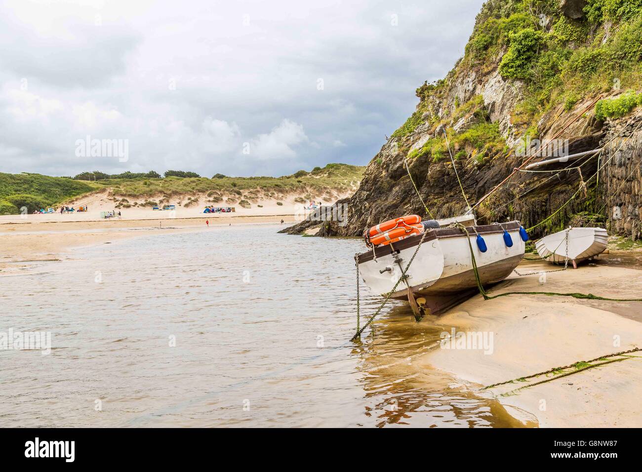 A boat house with boats on the river Gannel estuary, Crantock Beach ...