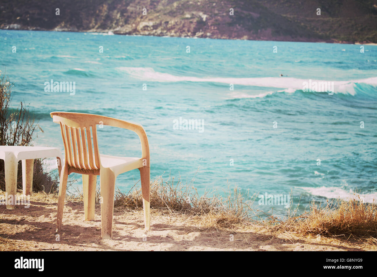 plastic chair by the sea in vintage tone Stock Photo - Alamy