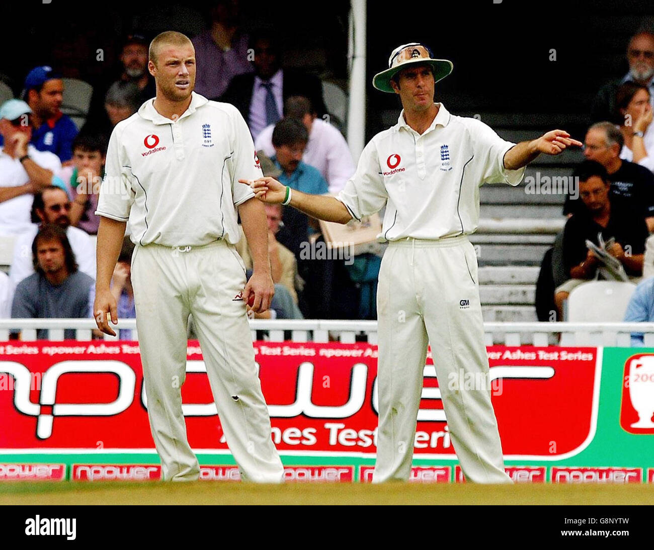 England's Andrew Flintoff (L) and Michael Vaughan arrange the field ...