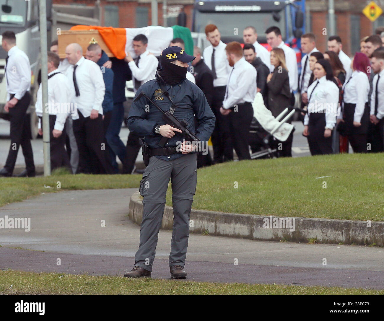 Armed Garda look on as the coffin of dissident republican Vincent Ryan ...