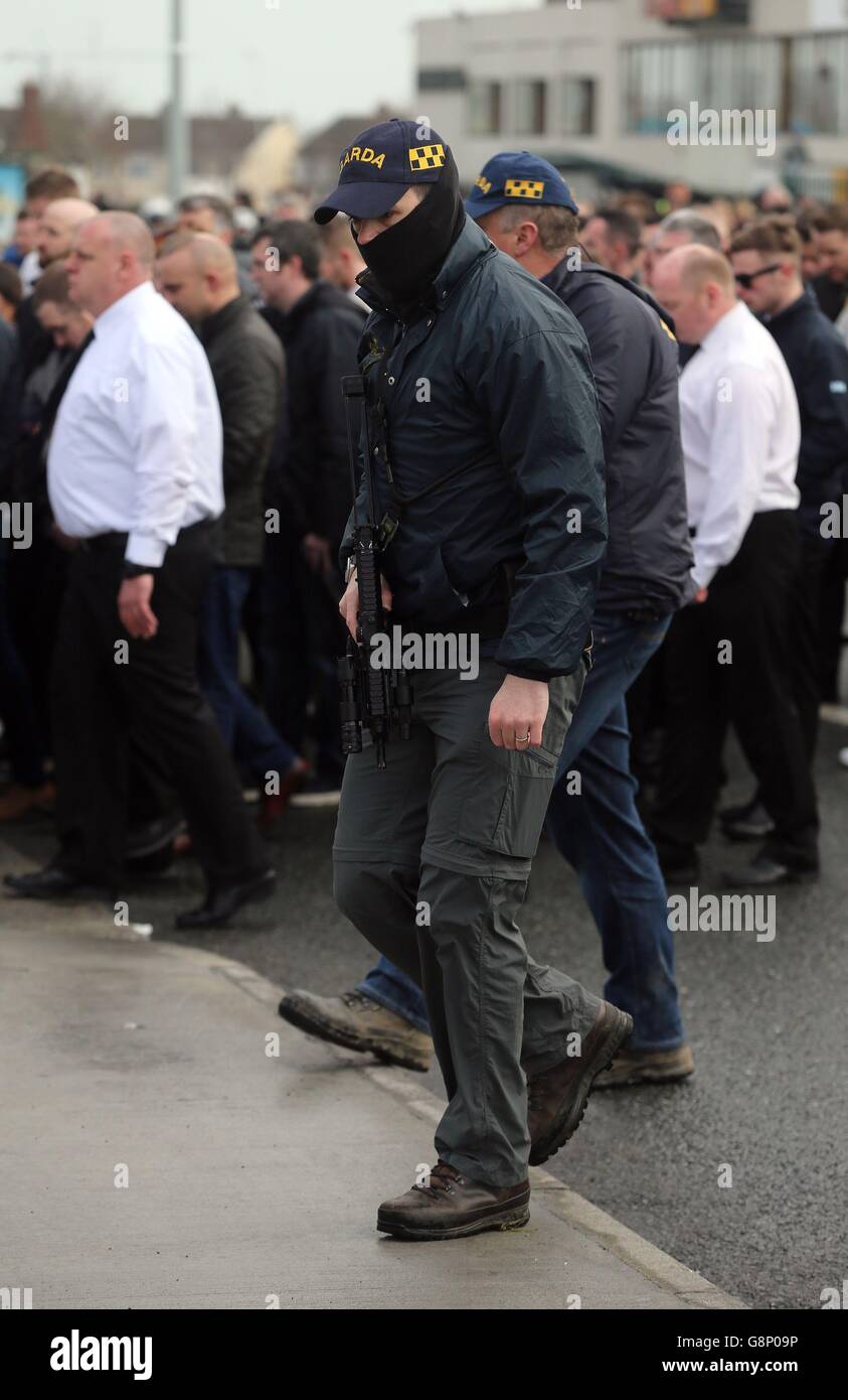 Armed Garda look on as the coffin of dissident republican Vincent Ryan ...