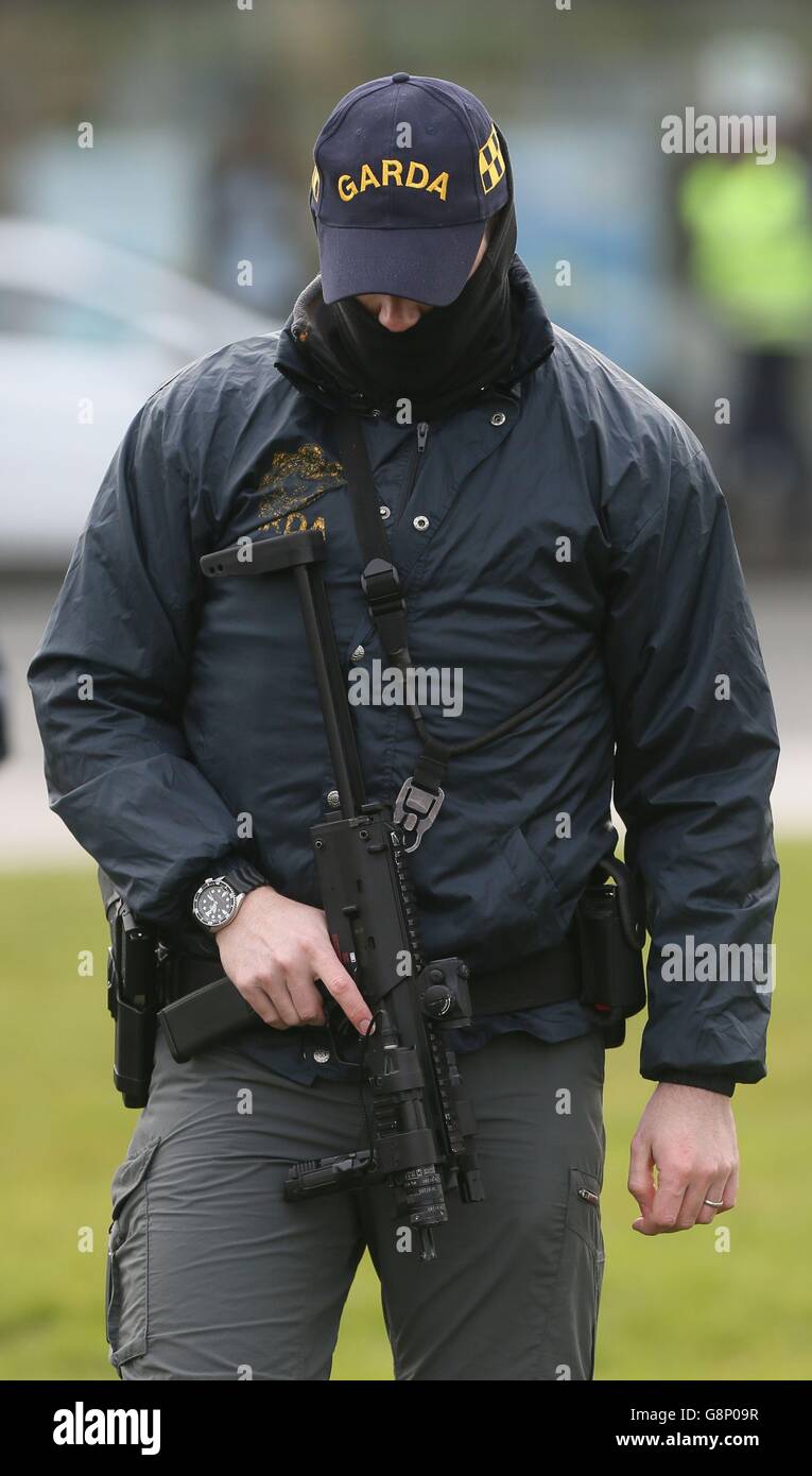 Armed Garda look on as the coffin of dissident republican Vincent Ryan ...