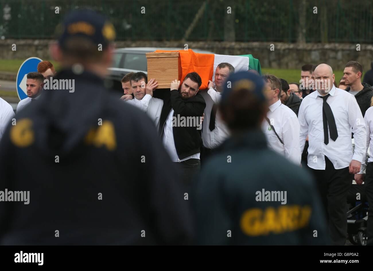 Armed Garda look on as the coffin of dissident republican Vincent Ryan ...