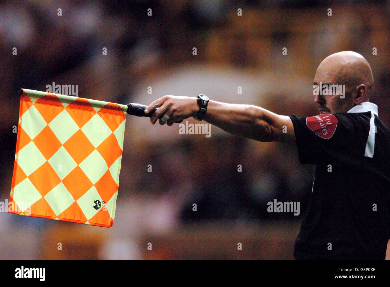 The assistant referee raises his flag for offside hi-res stock ...