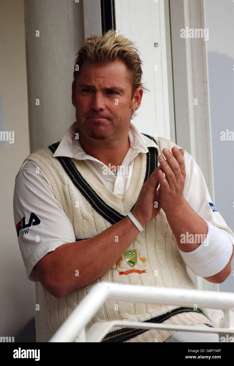 Australia's Shane Warne waits on the balcony during the fourth day of ...
