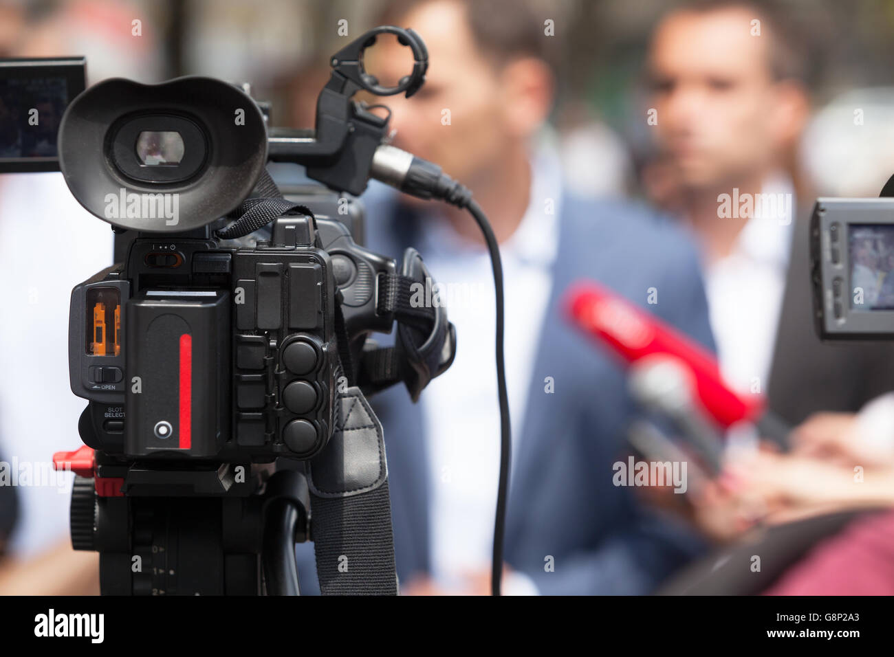 Filming press conference with a video camera. Spokesman Stock Photo - Alamy