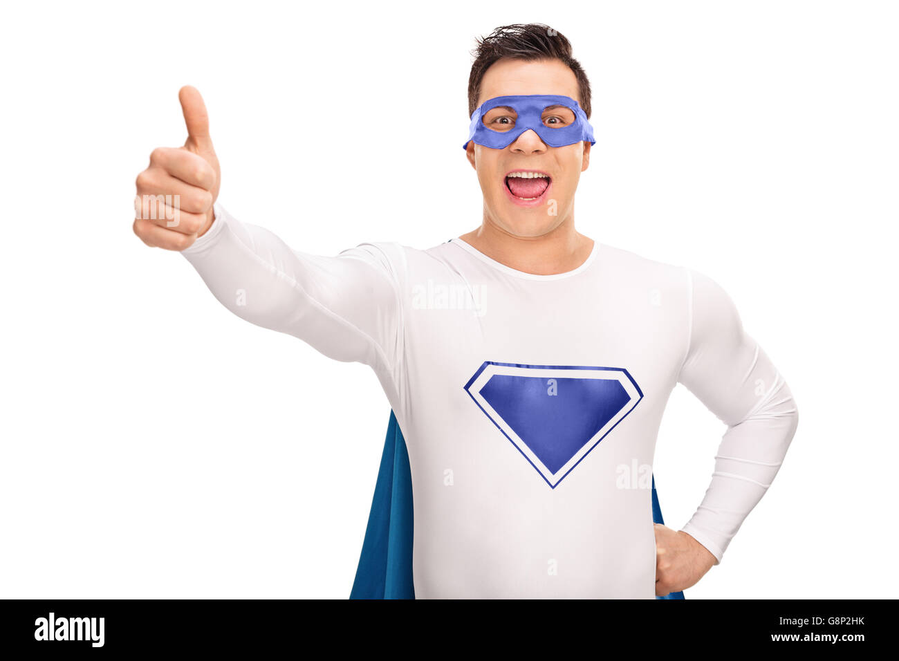 Joyful superhero giving a thumb up and looking at the camera isolated ...