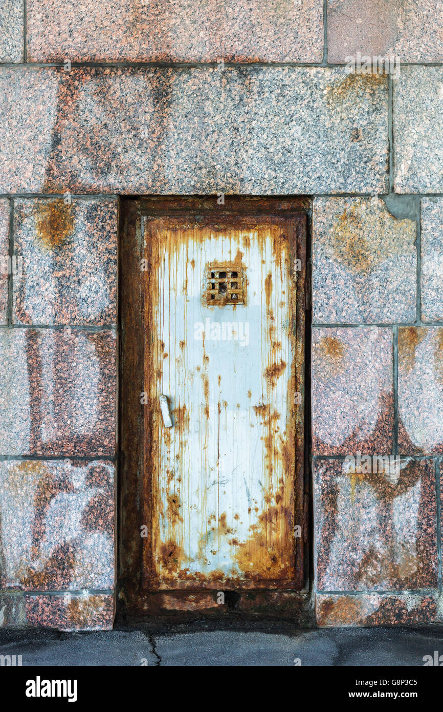 Rusty metal door on the background of a granite wall Stock Photo - Alamy