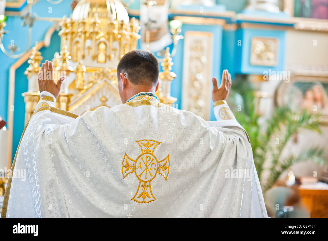 Mukyluntsi , Ukraine - 26 june, 2016: First holy communion. Priest ...