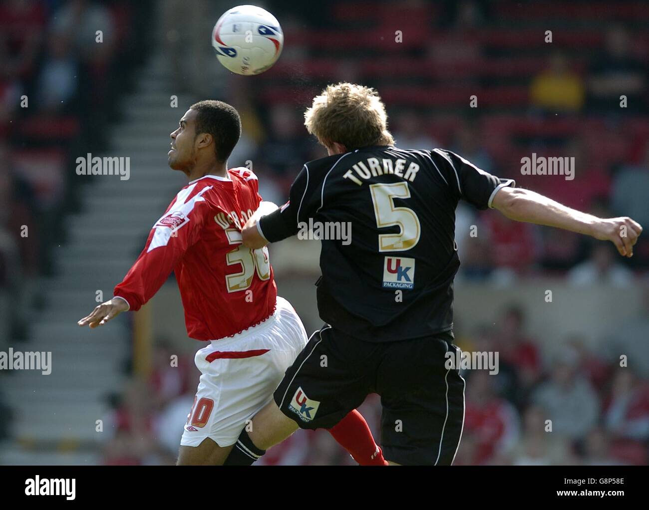 Brentford's Michael Turner clears the ball under a challenge from ...