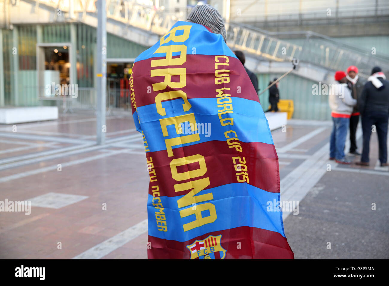 A Barcelona supporter wears a club flag ahead of the UEFA Champions ...