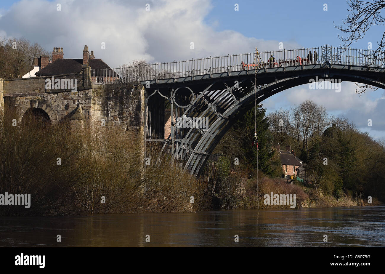 A surveyor abseils off the Iron Bridge over the River Severn in ...