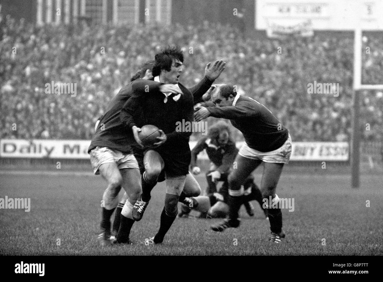 Wales's Jeff Young (r) stretches to help tackle New Zealand's Mike ...