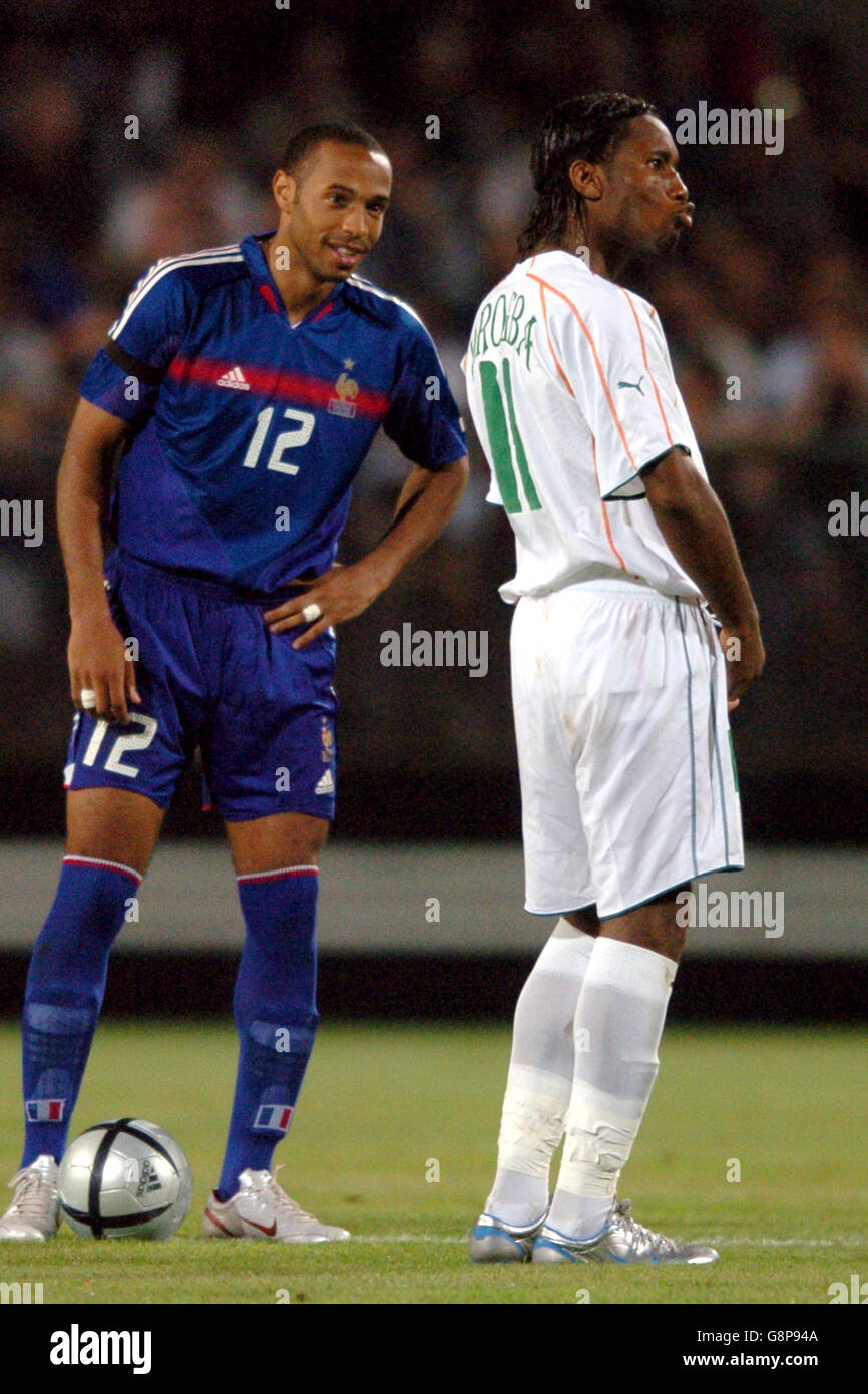 France's Thierry Henry smiles as Ivory Coast's Didier Drogba gestures ...
