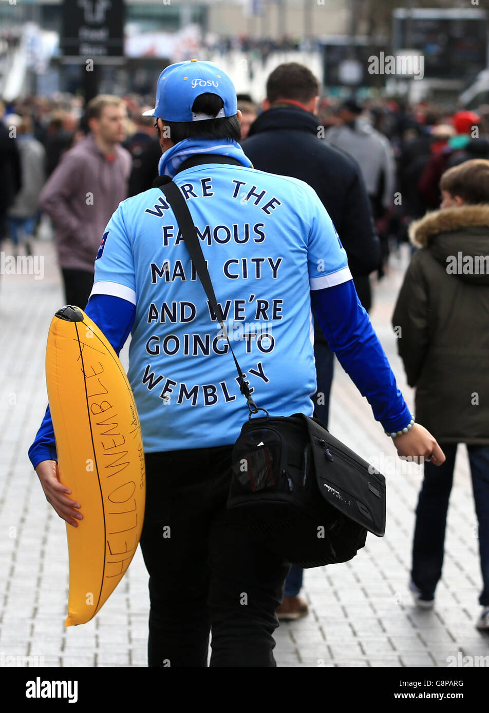 A Manchester City supporter makes their way up Wembley way with a ...