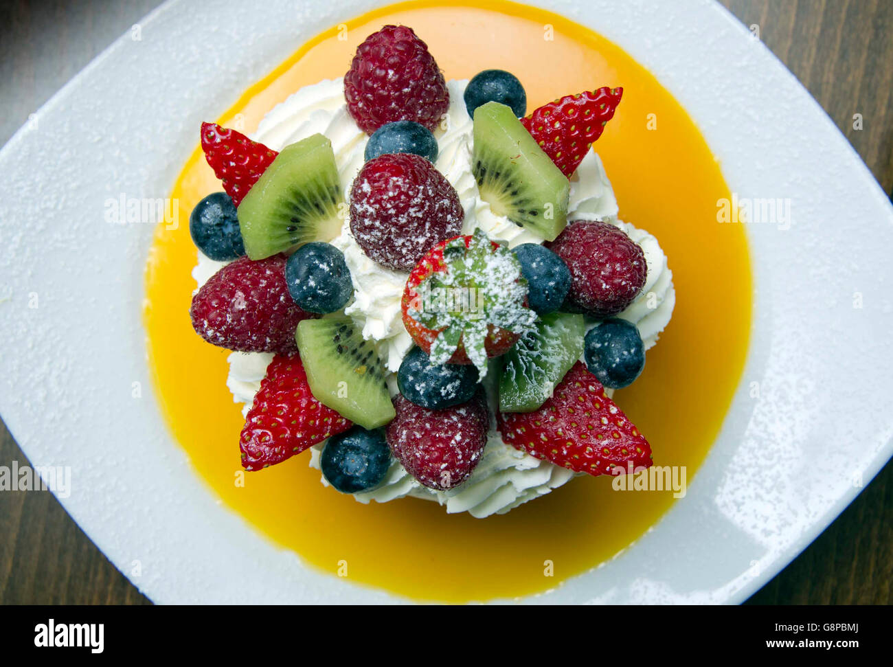 A mixed summer fruit pavlova dessert with strawberries,blackberries ...