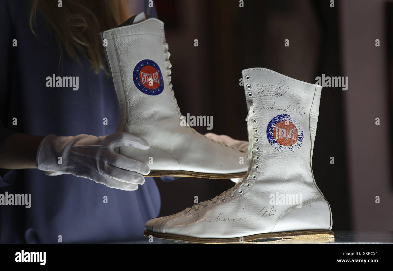 Exhibiton curator Sarah Foster checks a pair of signed boots worn by ...