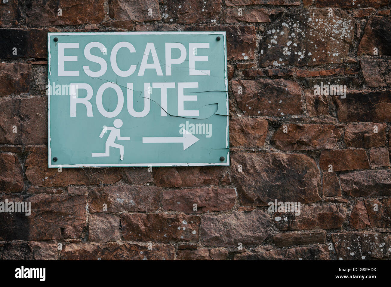 Color image of an Escape Route indicator on a brick wall Stock Photo ...