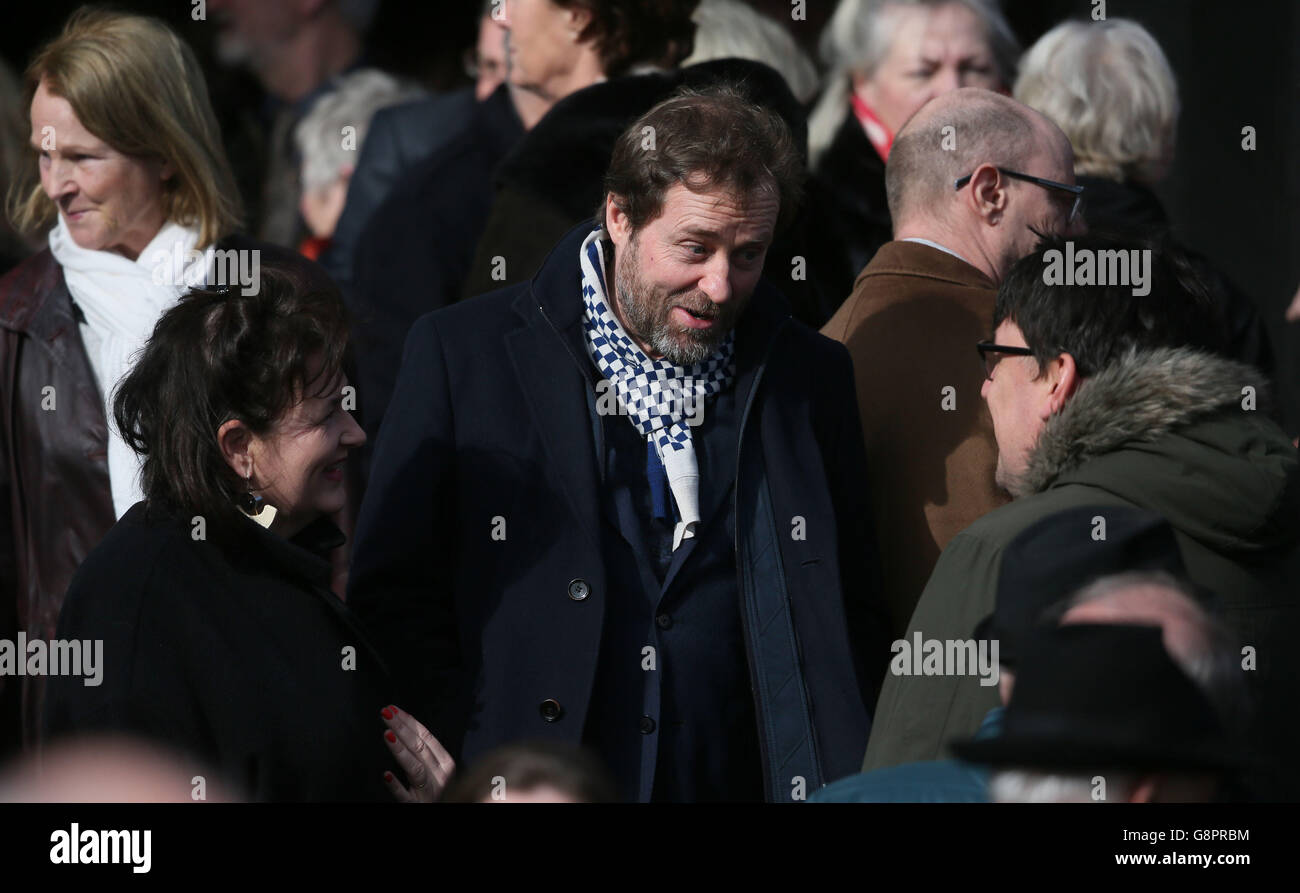 Ardal O'Hanlon (centre) chats with Graham Linehan at the funeral of ...