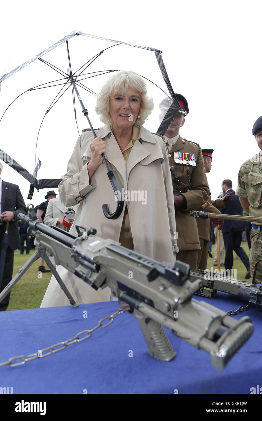 The Duchess of Cornwall is shown a light machine gun as she meets ...