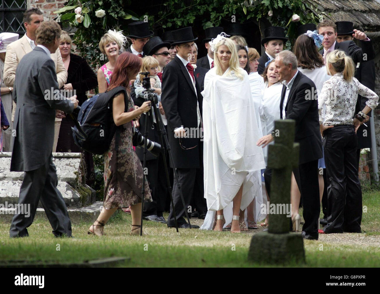 Bridesmaid Jemma Kidd (draped in white sheet) during the wedding of her ...